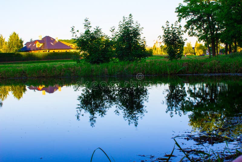 A Fairy-tale Lake in the Forest, the Trees are Reflected in the Water ...