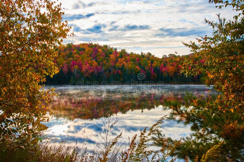 Fall Forest Surrounds Lake with Foggy Surface Stock Photo - Image of ...