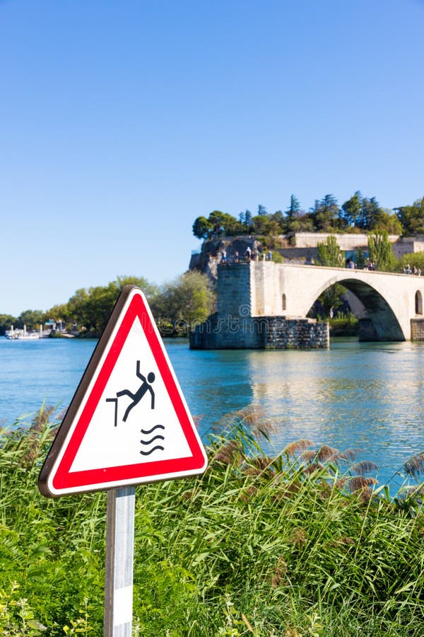 Fall Hazard Sign and Avignon Bridge in a Sunny Day Stock Photo - Image ...