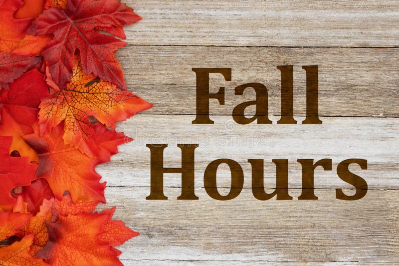 Fall Hours Message with Fall Leaves on Weathered Wood Stock Image ...