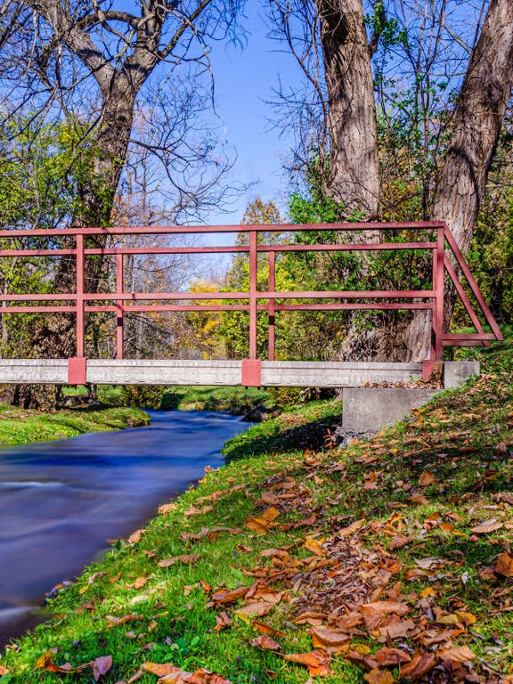 Fall View of a Pedestrian Bridge Over a Creek Stock Photo - Image of ...