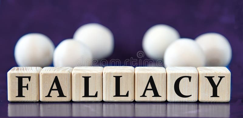 FALLACY - Word on Wooden Cubes on a Blue Background with Wooden Balls ...