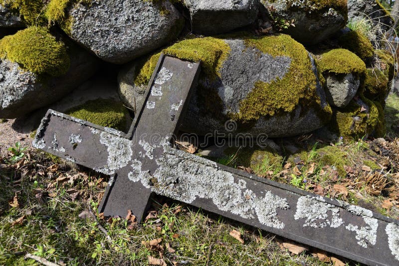 A Fallen Cross and a Pile of Moss Covered Stones in a Cemetery ...