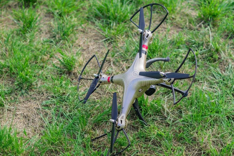 Fallen Drone on Green Grass after Remote Control Disconnection Stock ...