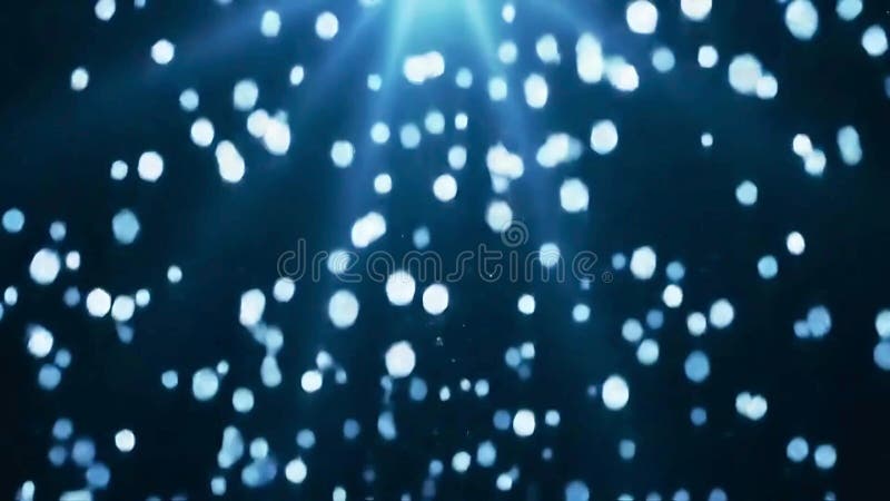Falling Blue Glitter Particles Illuminated by Rays of Light Stock ...