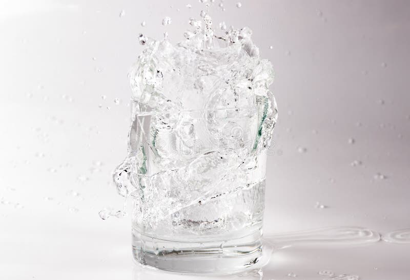 Falling and Crashing Glass of Water. Shards of Glass and Splashing ...