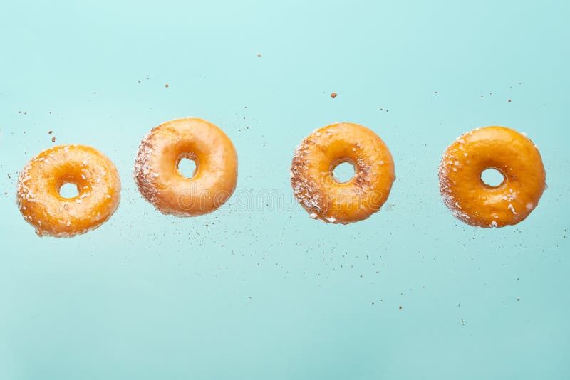 Falling Donuts with Chocolate on a Light Blue Background. Freezing in ...