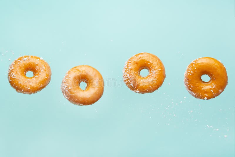 Falling Donuts in a Glaze on a Blue Background Stock Image - Image of ...