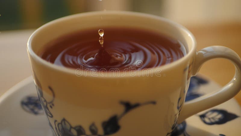 Falling drop into tea cup stock photo. Image of cafe - 234790878