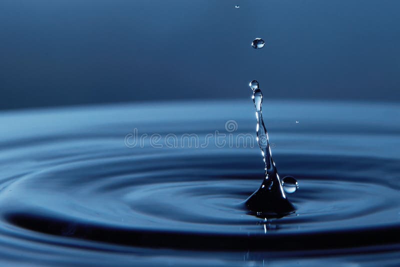Falling Drop of Water Closeup on a Dark Blue Background Stock Photo ...