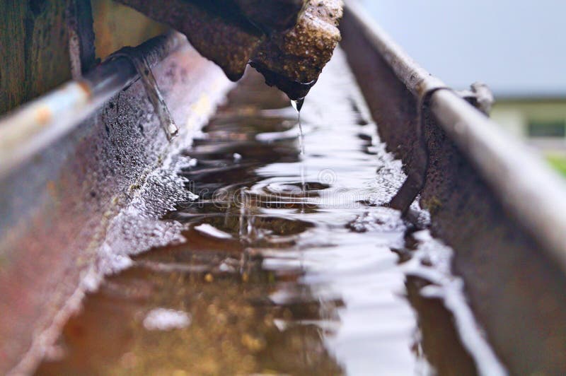 A Falling Drop of Water on the Gutter. Stock Photo - Image of middle ...