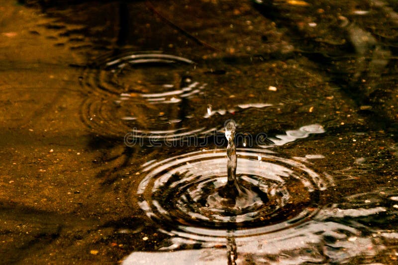 Falling Drop of Water in a Puddle Stock Image - Image of droplet ...