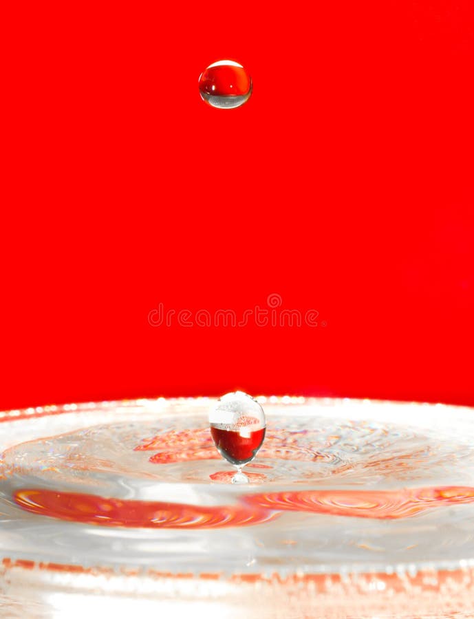 Falling Droplets of Water Over Red Stock Photo - Image of colorful ...