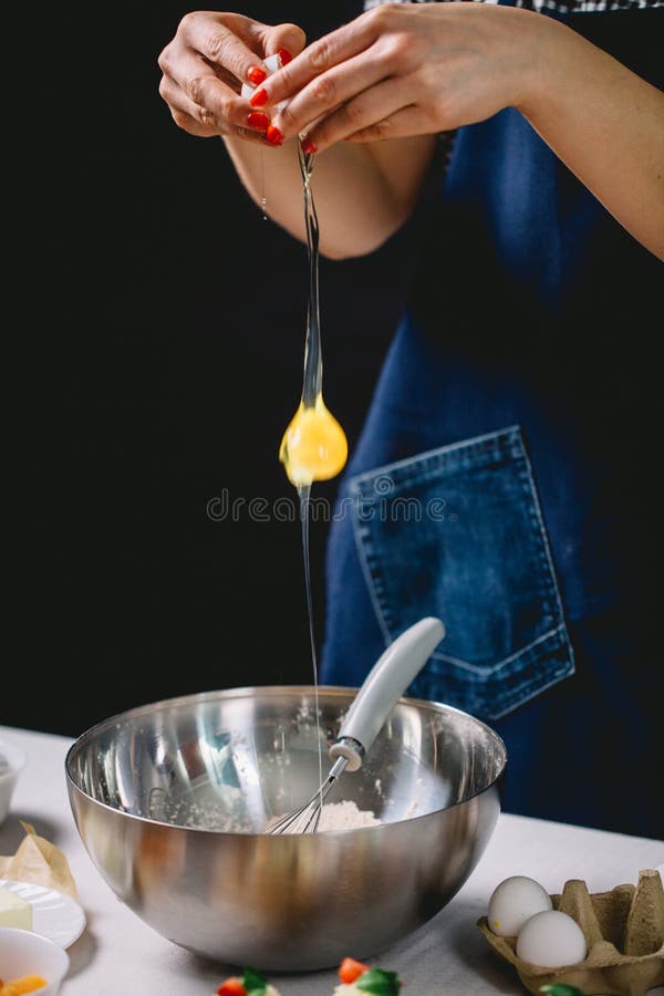 Confectioner Breaking an Egg To Separate Egg White and Yolks Stock ...