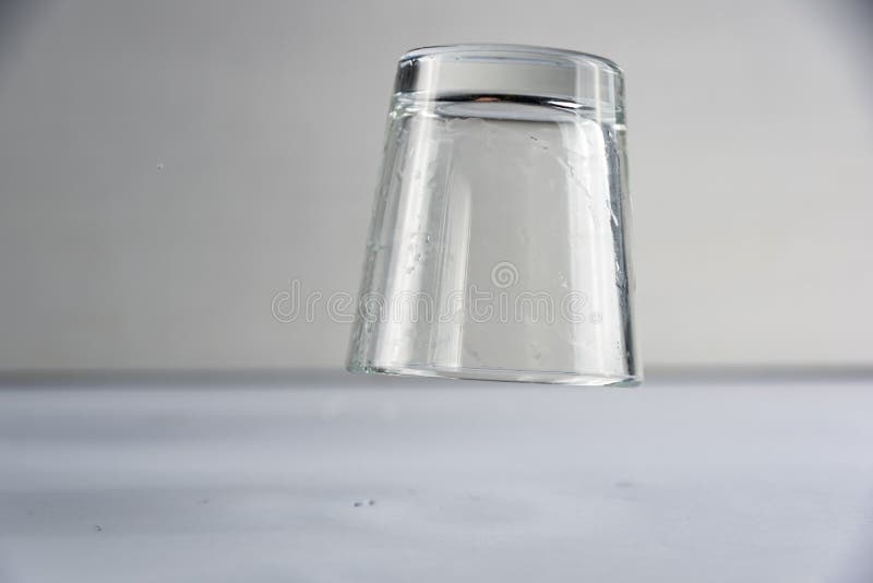Falling, Flying or Standing Glass with a Clear Liquid Intended for ...