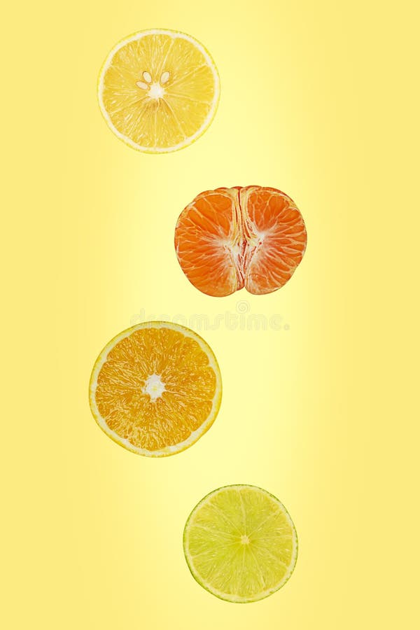 Falling Halves of Orange, Lemon, Lime and Mandarin Isolated on Yellow ...