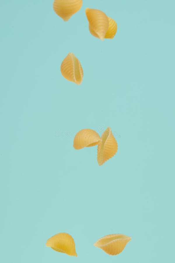 Falling Italian Pasta on a Light Blue Background, Freezing in Motion ...