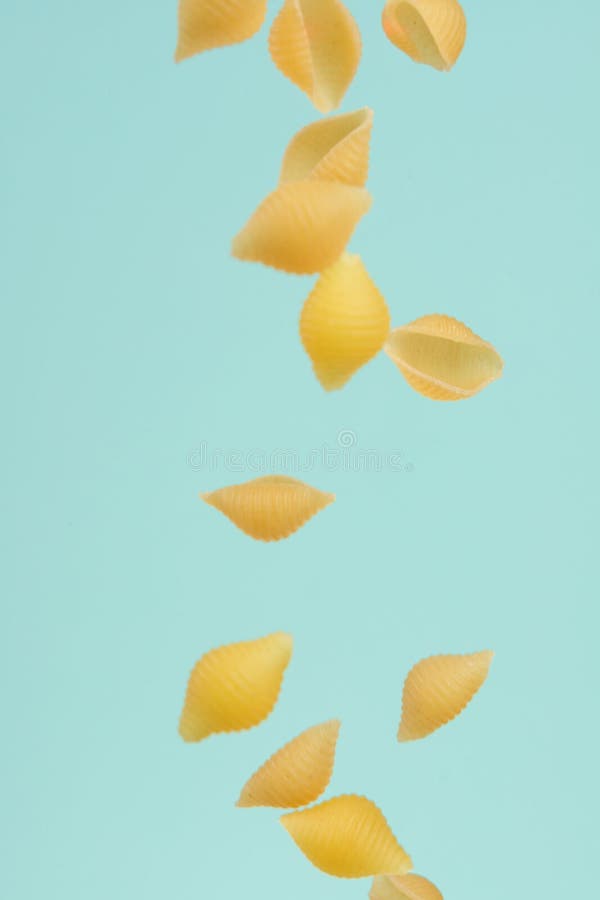 Falling Italian Pasta on a Light Blue Background, Freezing in Motion ...
