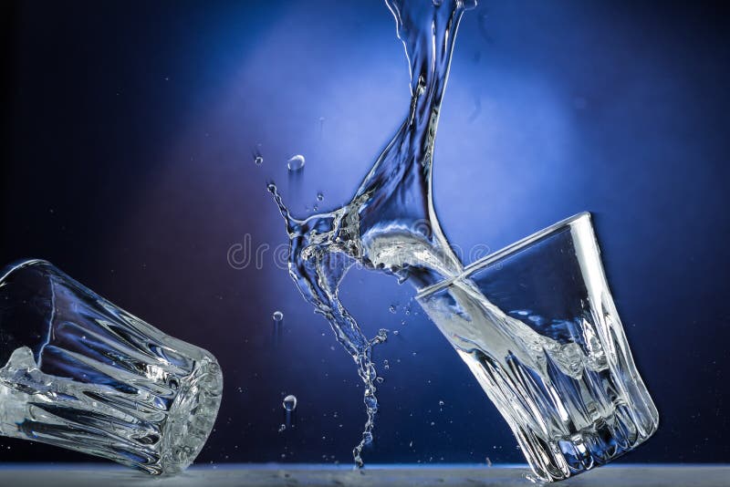 Falling and Jumping Glass with Spilling Liquid on a Blue Gradient ...