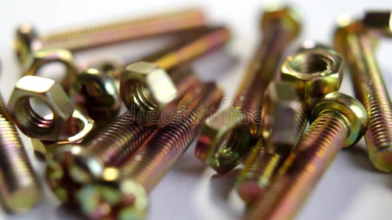 Falling Metal Bolts and Nuts on a White. Threaded Hardware for ...