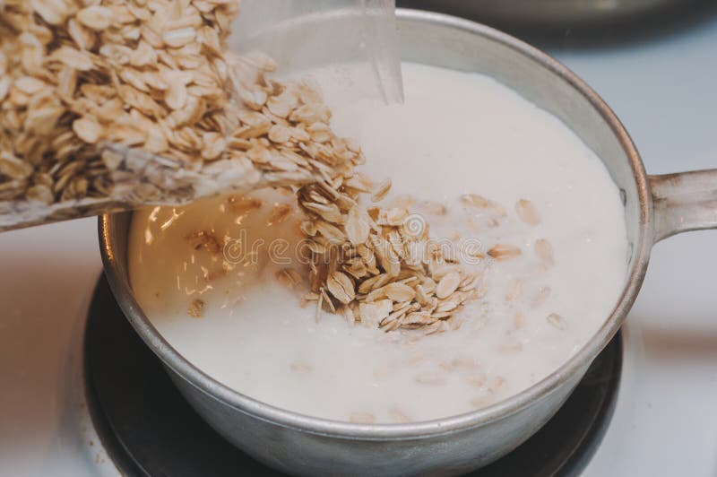 Falling Oatmeal into Hot Milk. Steaming Oatmeal Stock Photo - Image of ...