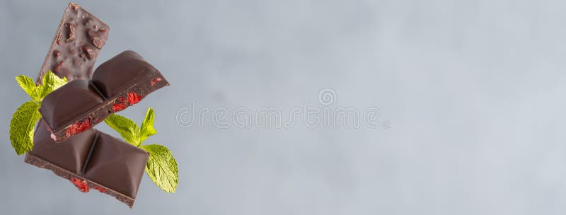 Falling Pieces of Chocolate and Mint Leaves on a Light Background Stock ...