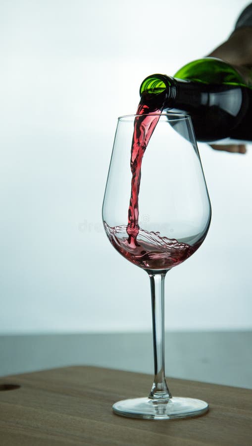 Falling red wine in glass stock image. Image of burgundy - 83748863