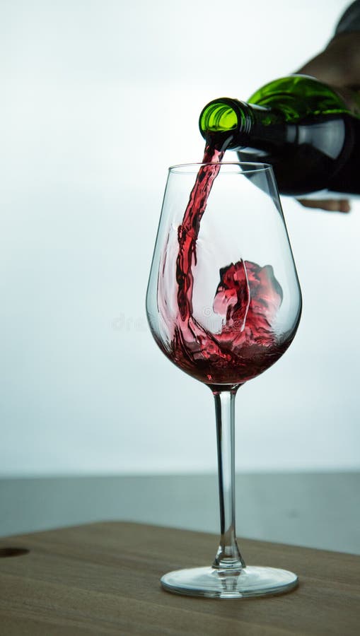 Falling red wine in glass stock image. Image of cheers - 83749349