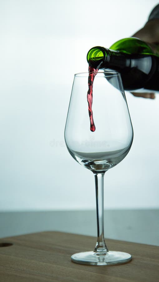 Falling red wine in glass stock photo. Image of display - 83748956