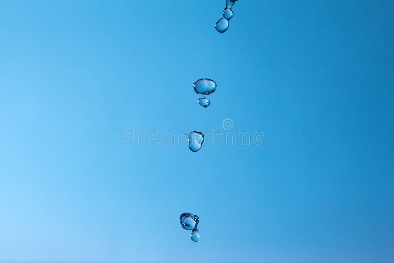 Falling Water Drops on a Blue Background Stock Photo - Image of aqua ...