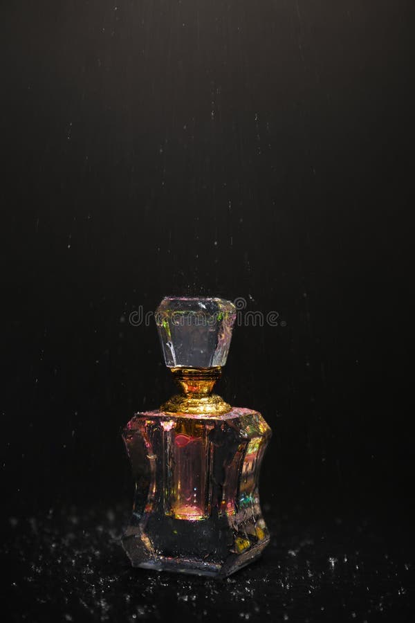 Falling Water Drops Over Perfume Bottle on Dark Background Stock Image ...