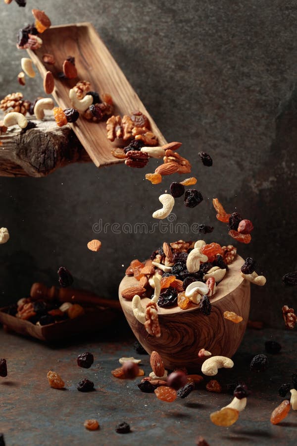 Falling Dish with Nuts and Raisins Stock Photo - Image of food ...