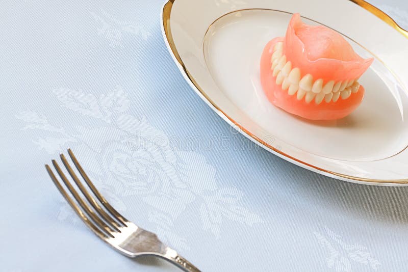 False teeth on white plate stock image. Image of hard - 31383693