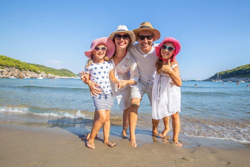 Familia Feliz Que Juega En La Playa Foto de archivo - Imagen de arena ...