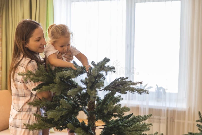 Family Assembling, Shaping Hook-in Artificial Christmas Tree at Home ...