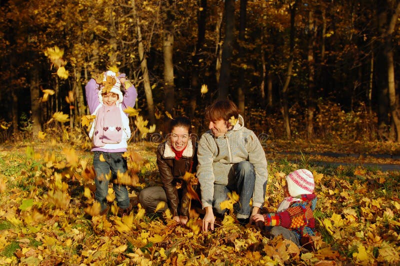 Family Throwing Autumn Leaves into the Air Stock Photo - Image of male ...