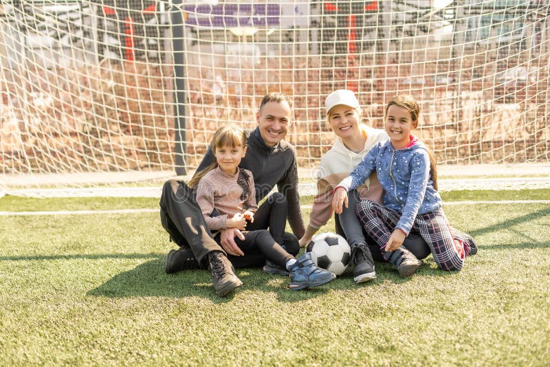 Family and Ball on the Grass in the Stadium Stock Image - Image of ...
