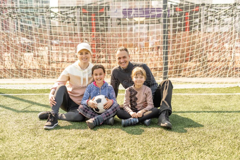 Family and Ball on the Grass in the Stadium Stock Photo - Image of ...
