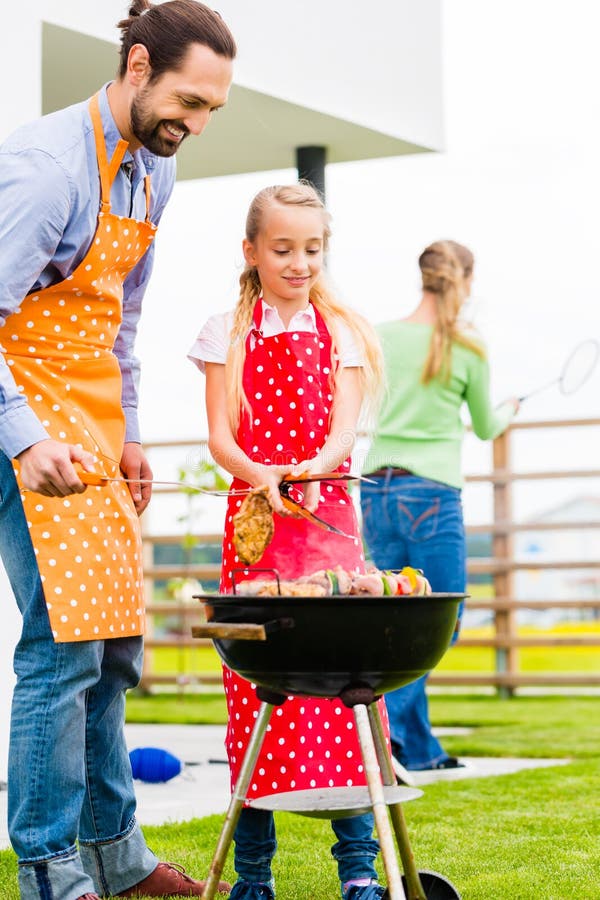 Family Barbecue in Garden Home Stock Image - Image of mother, preparing ...