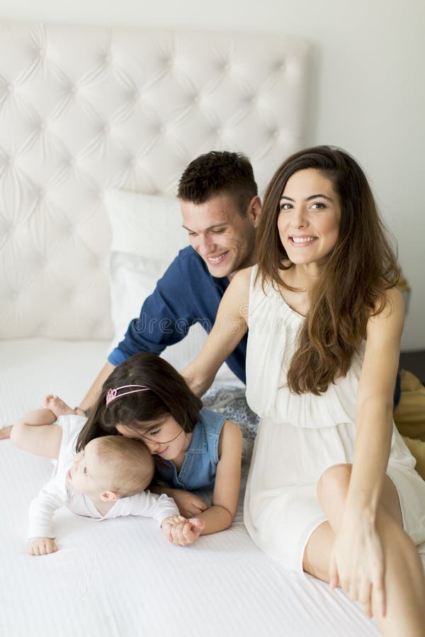Family on the bed stock photo. Image of happy, young - 70038028