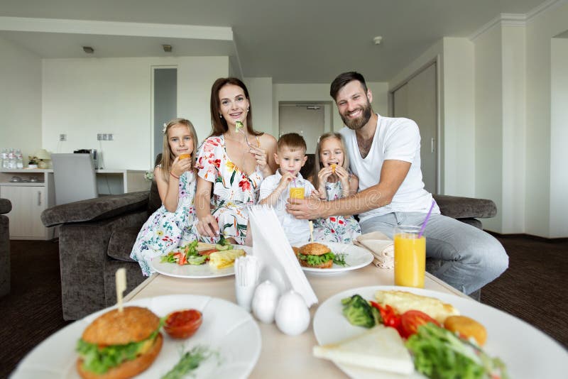 Close-up Portrait of a Mother and Twin Daughters Hugging and Smiling in ...