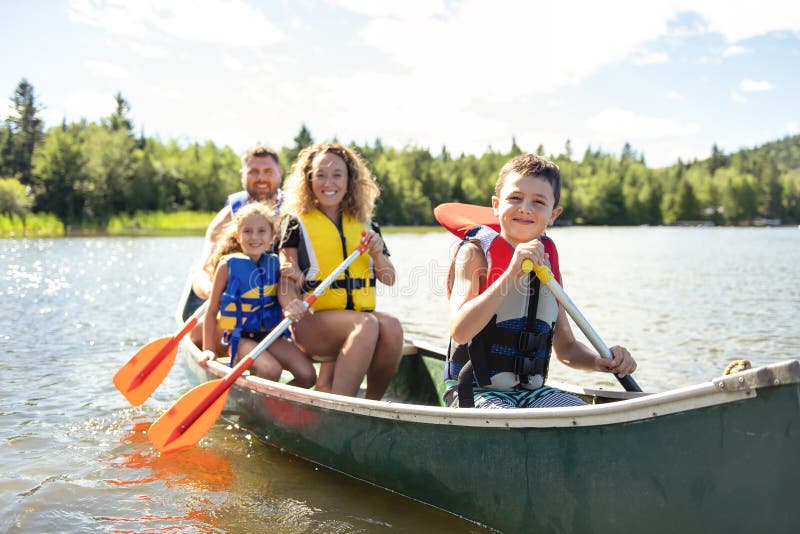 Family in a Canoe on a Lake Having Fun Stock Photo - Image of reflect ...