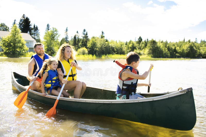 Family in a Canoe on a Lake Having Fun Stock Photo - Image of pond ...