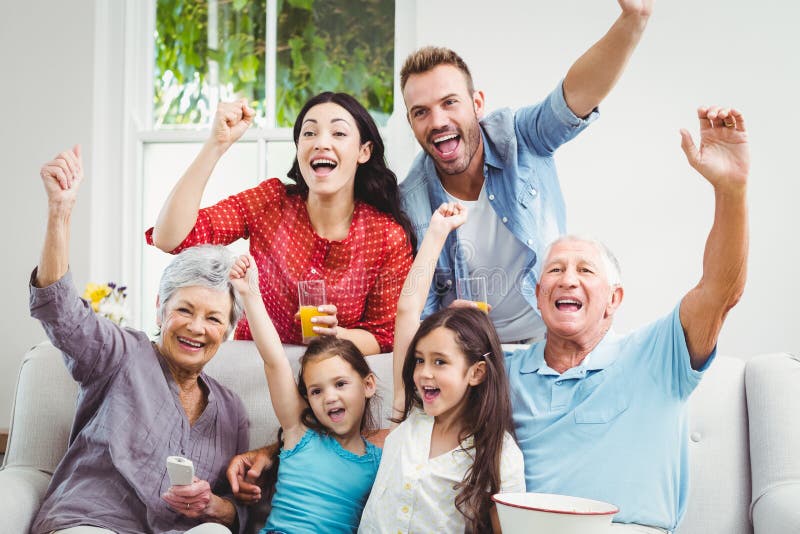 Family Cheering while Watching Television Stock Image - Image of girl ...