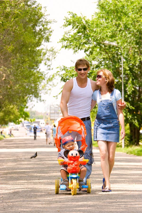 Family with Child in Stroller Walking Across Park Stock Image - Image ...