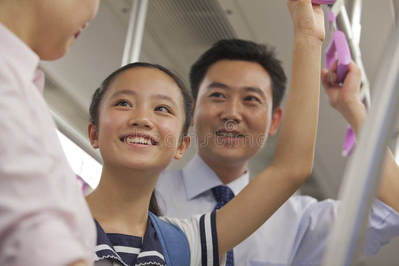 Family Commuting Together and Smiling in the Subway Stock Photo - Image ...