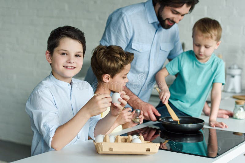 Family Cooking Eggs for Breakfast Together in Kitchen Stock Photo ...