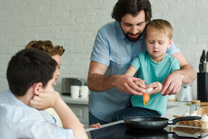 Family Cooking Eggs for Breakfast Together in Kitchen Stock Image ...