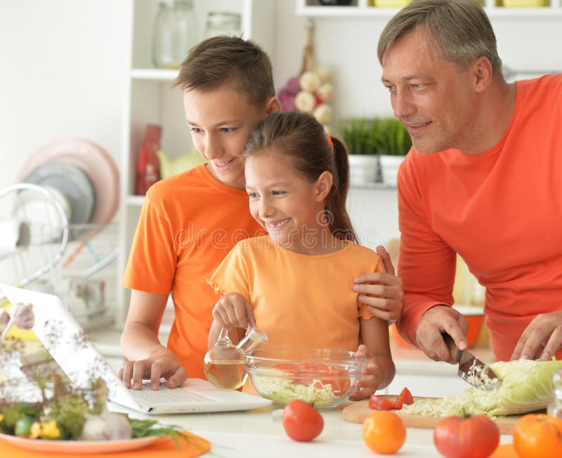 Portrait of Family Cooking Together at Kitchen Table Stock Photo ...