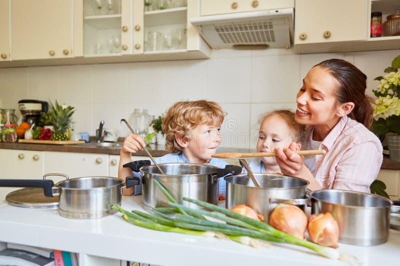 Family Cooking Together in Kitchen with Two Children Stock Image ...